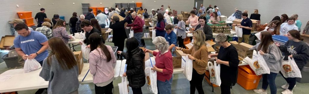 Administrators, Teachers, Students Packing For Weekend Backpack Program ...