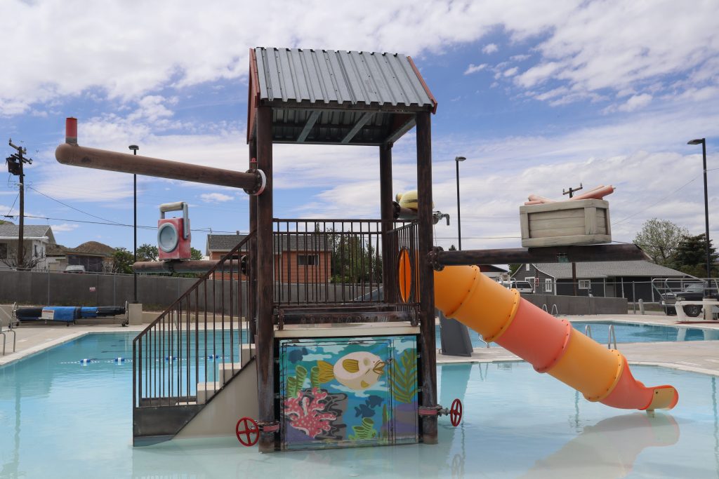 Helper cuts the ribbon to celebrate new improvements to city pool ...