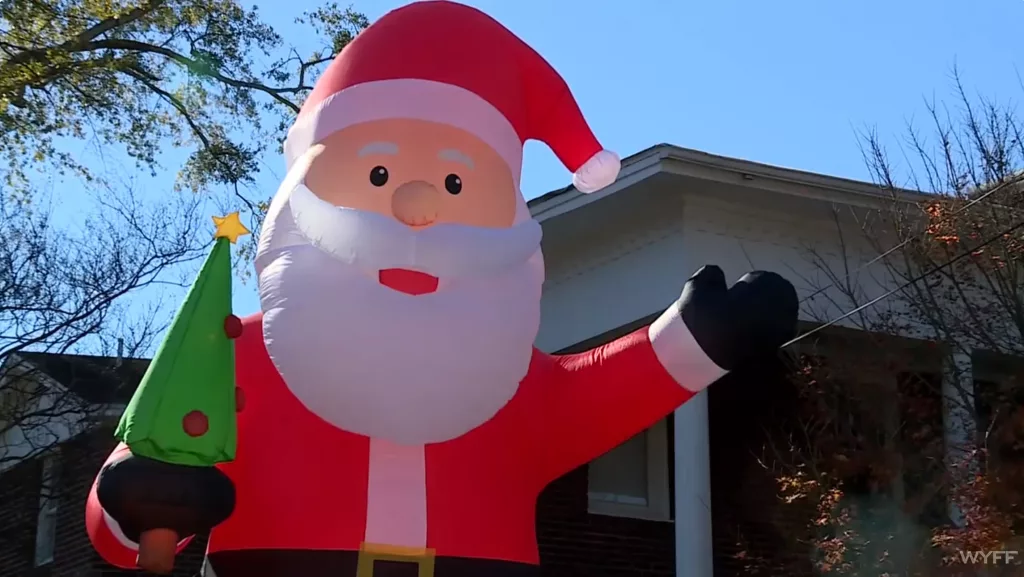 'Go big': 40 huge inflatable Santas line one street and it's quite a ...