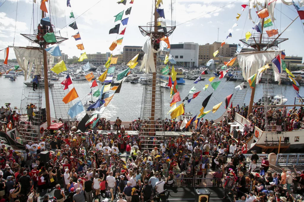 Revelers in festive dress fill downtown Tampa, Florida, for the annual ...