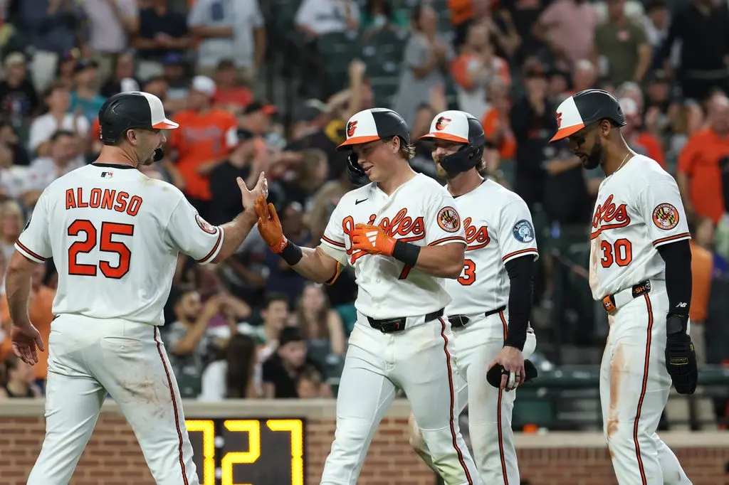 Holliday hits grand slam and Young pitches Orioles past Mariners 7-2 to ...