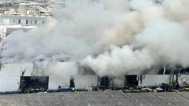LA warehouse fire continues to burn as officials warn residents of air ...